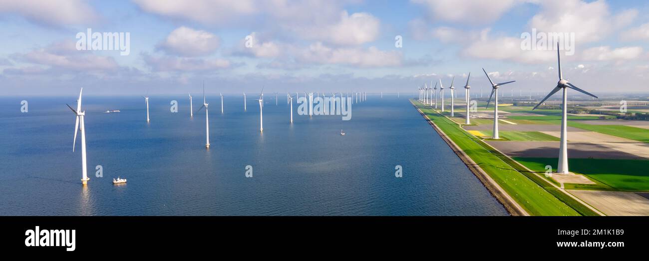 Drone Aerial view at Windmill park with windmills turbines in the ocean ...