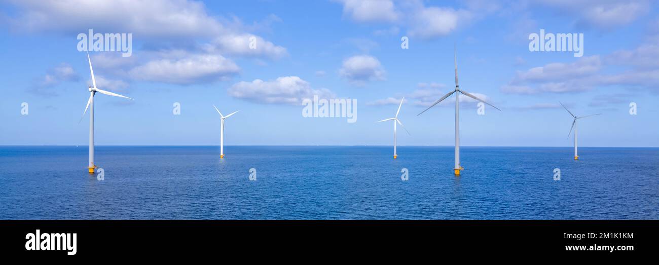 Drone Aerial view at Windmill park with windmills turbines in the ocean ...