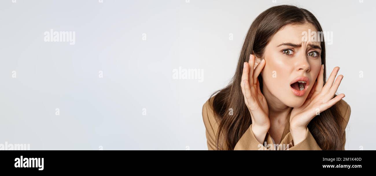 Image of sad girl looking in mirror and touching facial skin, shocked ...