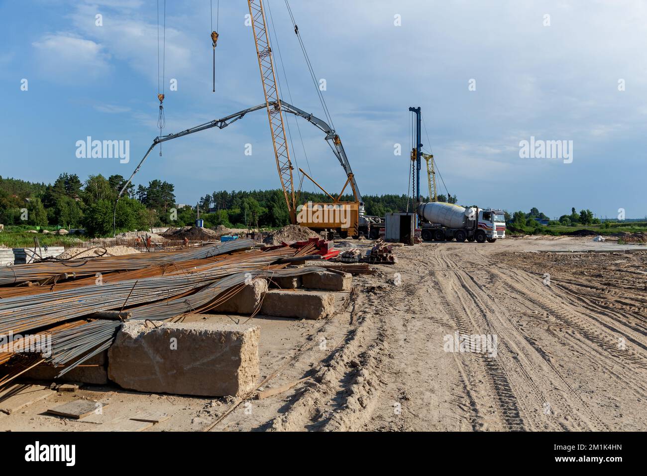 Construction site with construction equipment, rebar and foundation of ...