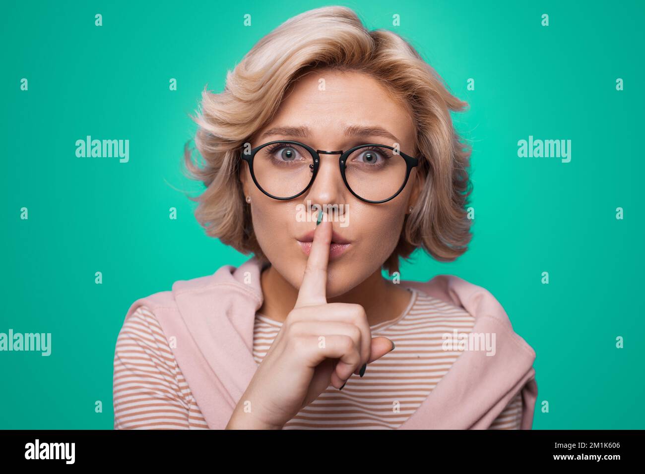 Photo of pretty lady hand finger cover lips demonstrate shh gesture ...