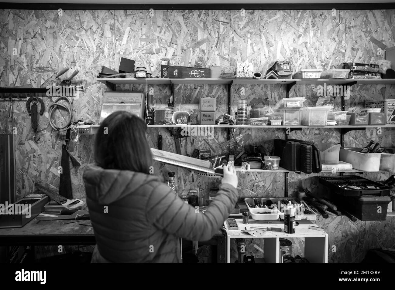 female working in a tool workshop. measuring timber in australia Stock ...
