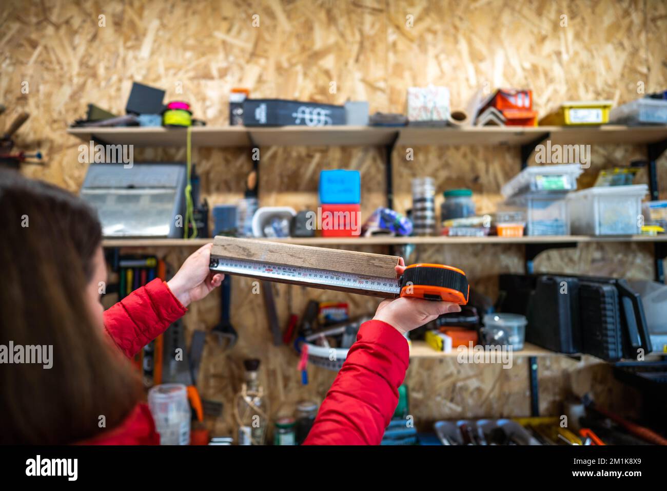 female working in a tool workshop. measuring timber in australia Stock ...