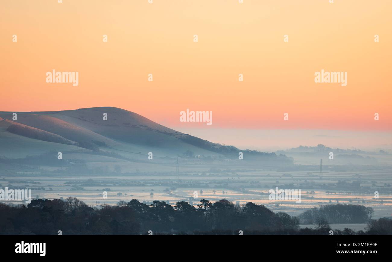 Misty morning December sunrise over mount Caburn from Kingston Ridge on ...