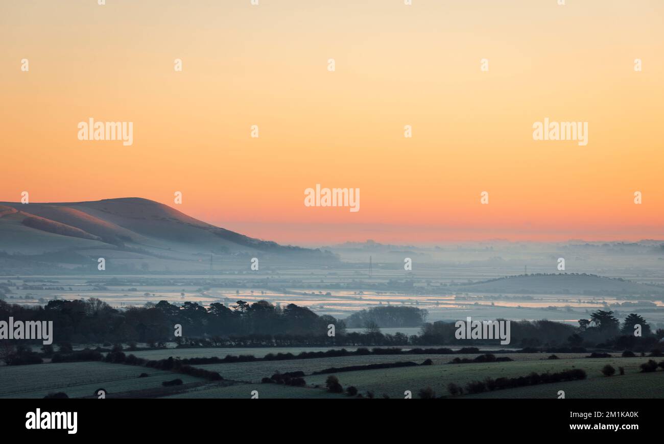 Misty morning December sunrise over mount Caburn from Kingston Ridge on ...