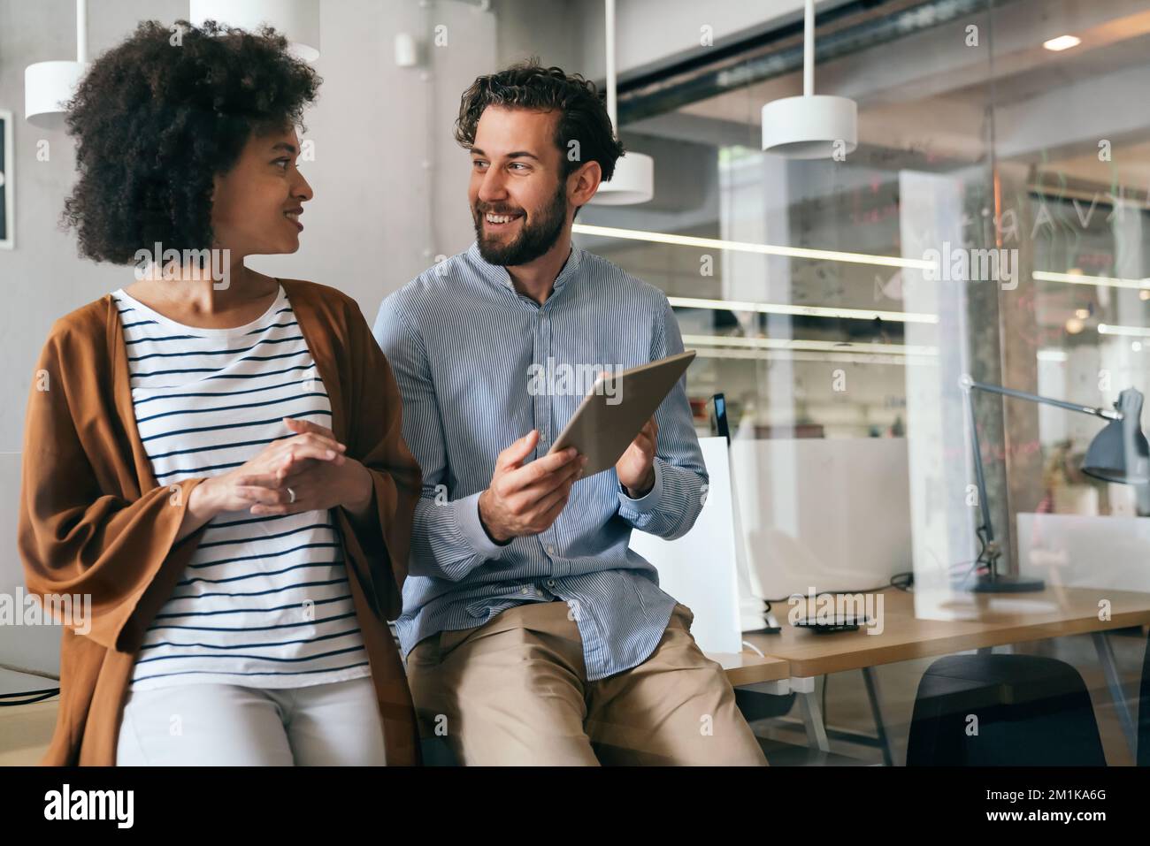 Successful business people, designer enjoying work together. Business ...