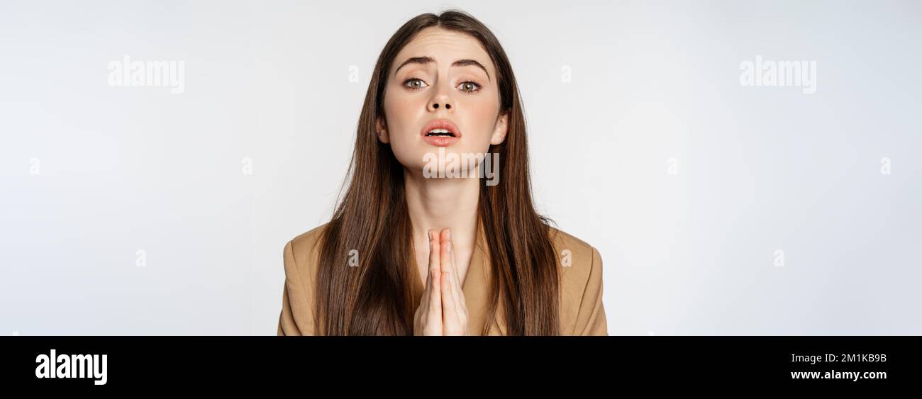 Close up portrait of corporate woman begging, pleading and saying ...