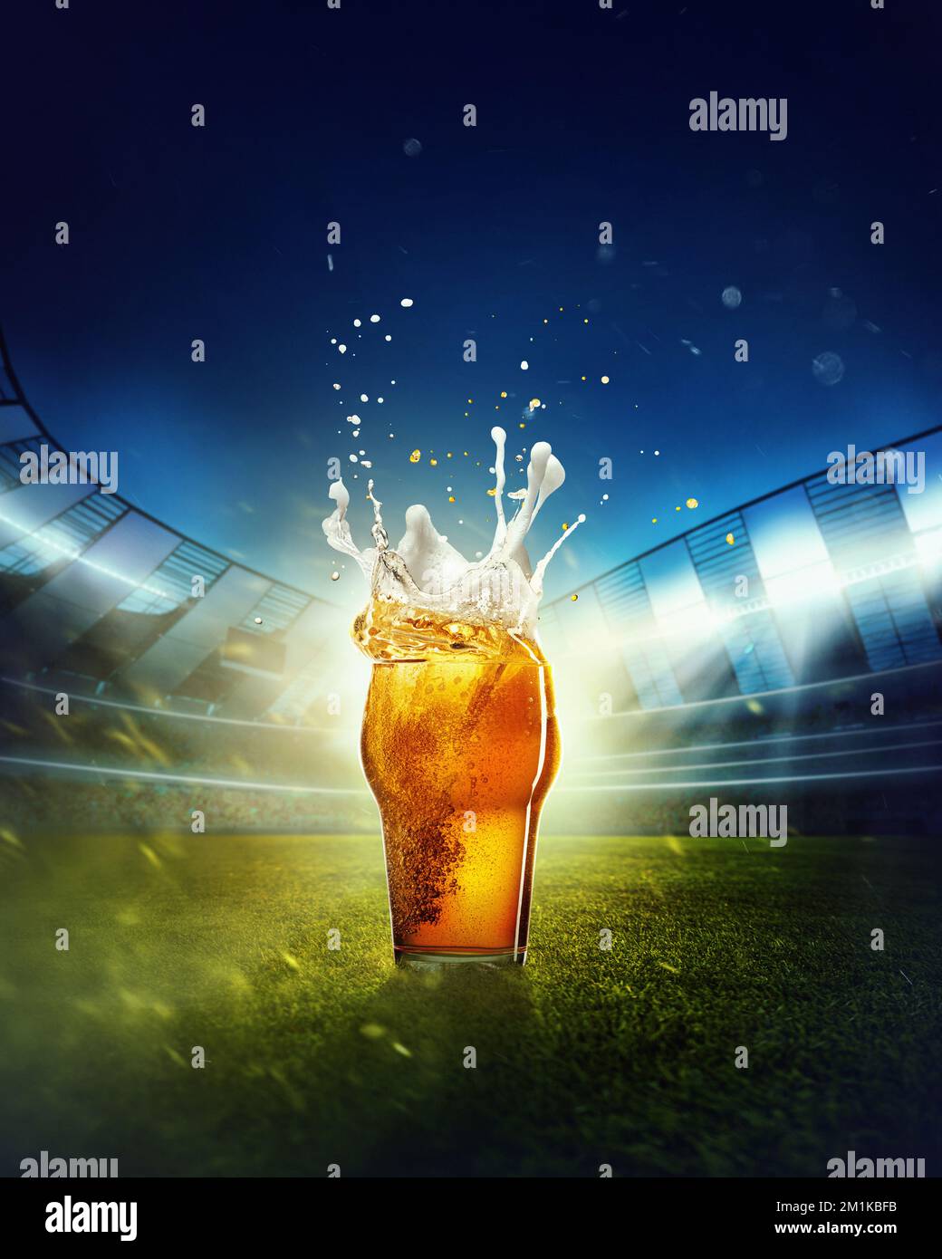 Glass with chill lager foamy beer standing on grass at football stadium ...