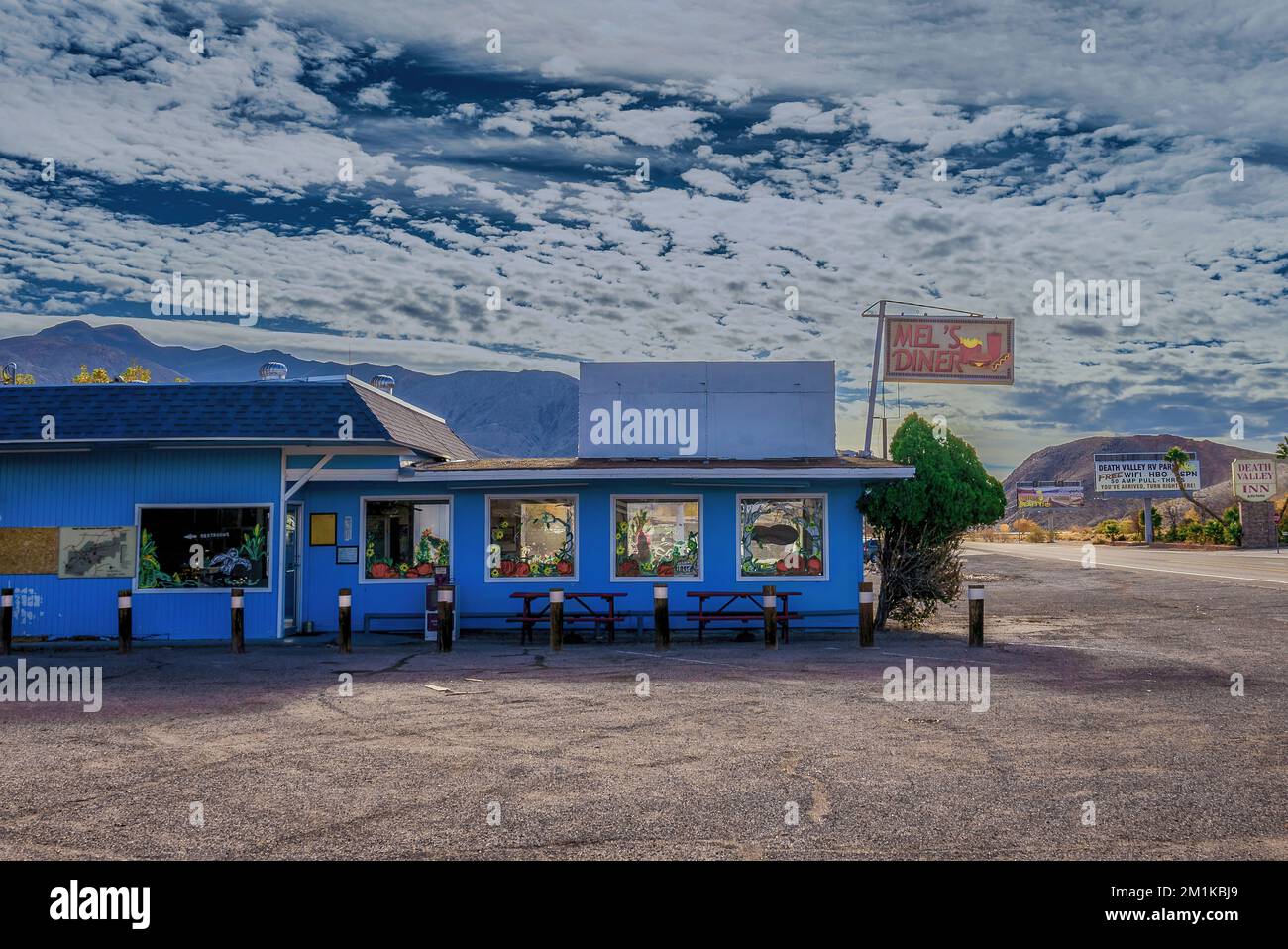 A scene of the Ghost Town with an old blue cafe during the daytime in ...
