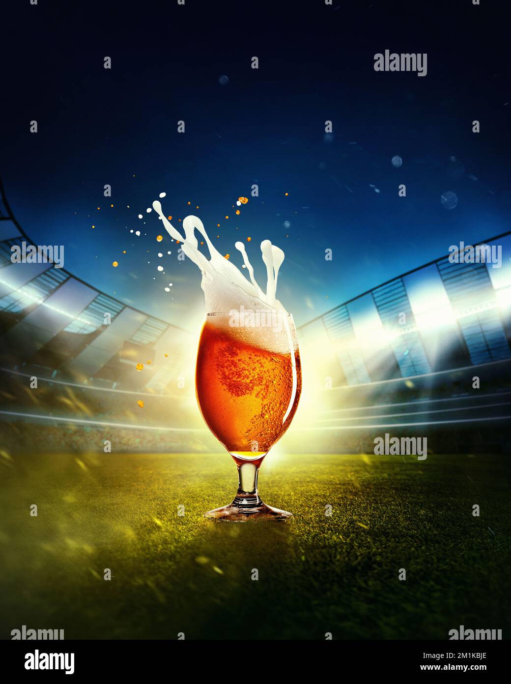 Foam and drops. Glass of cool lager beer standing on grass at football ...