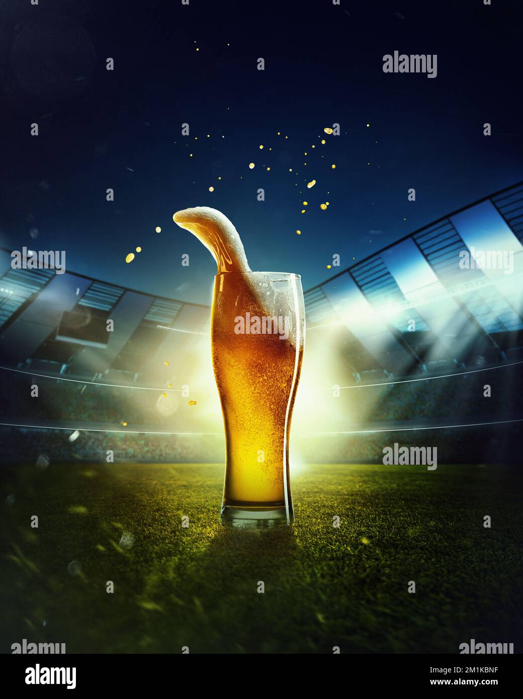 Splashes and bubbles. Glass with light chill beer on grass at football ...