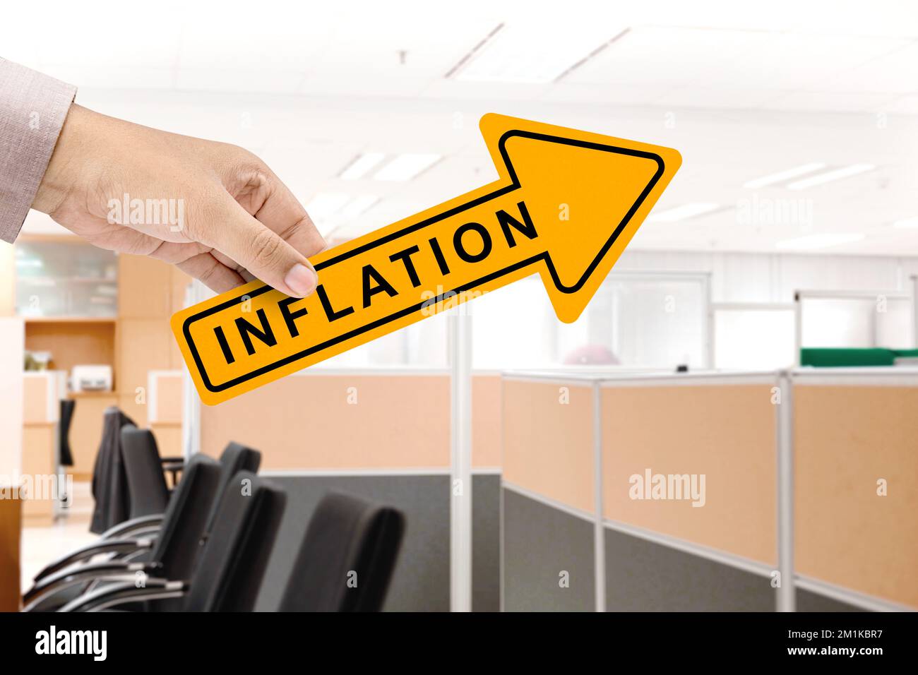Businessman's hand holding inflation sign on the office Stock Photo - Alamy
