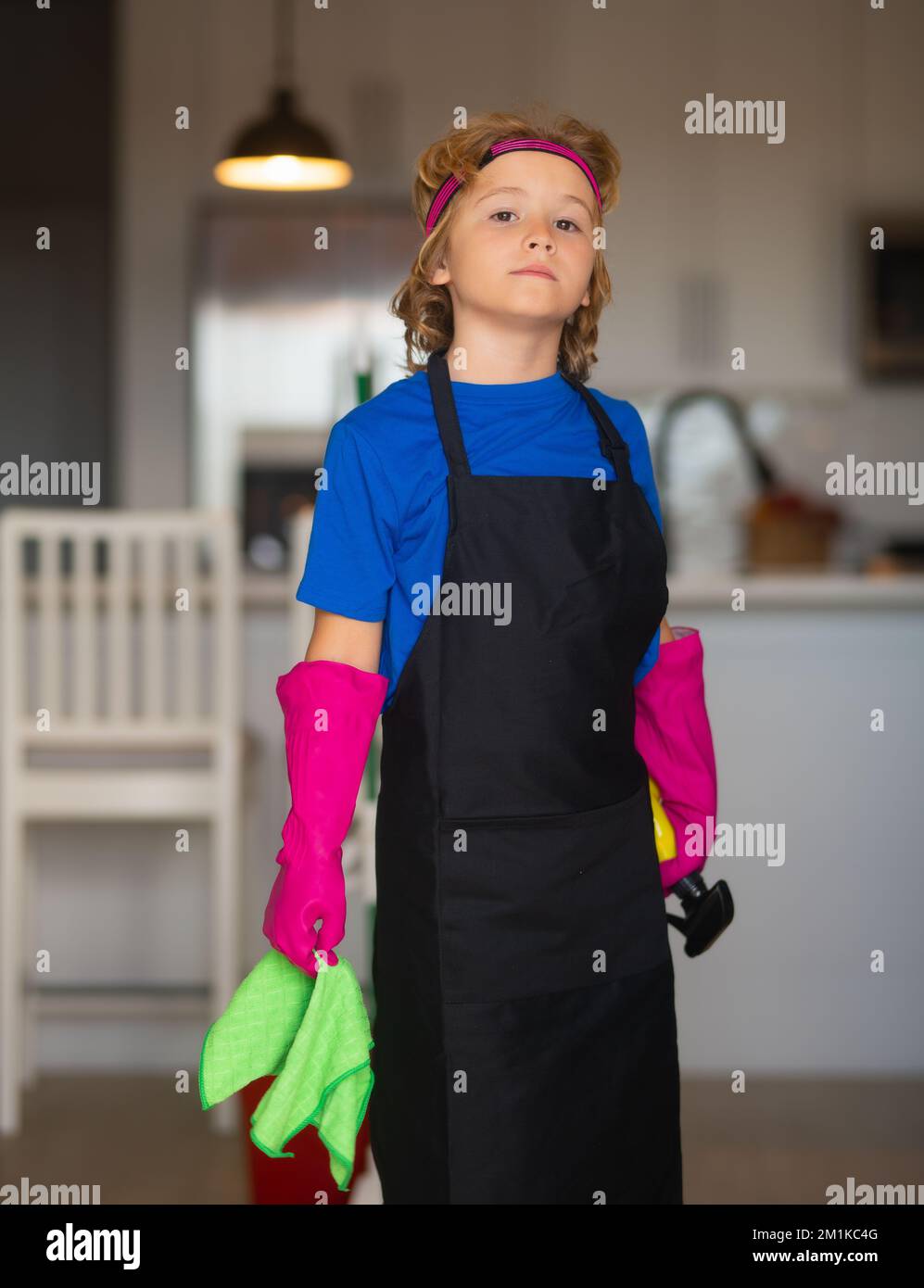 Portrait of child helping with housework, cleaning the house ...