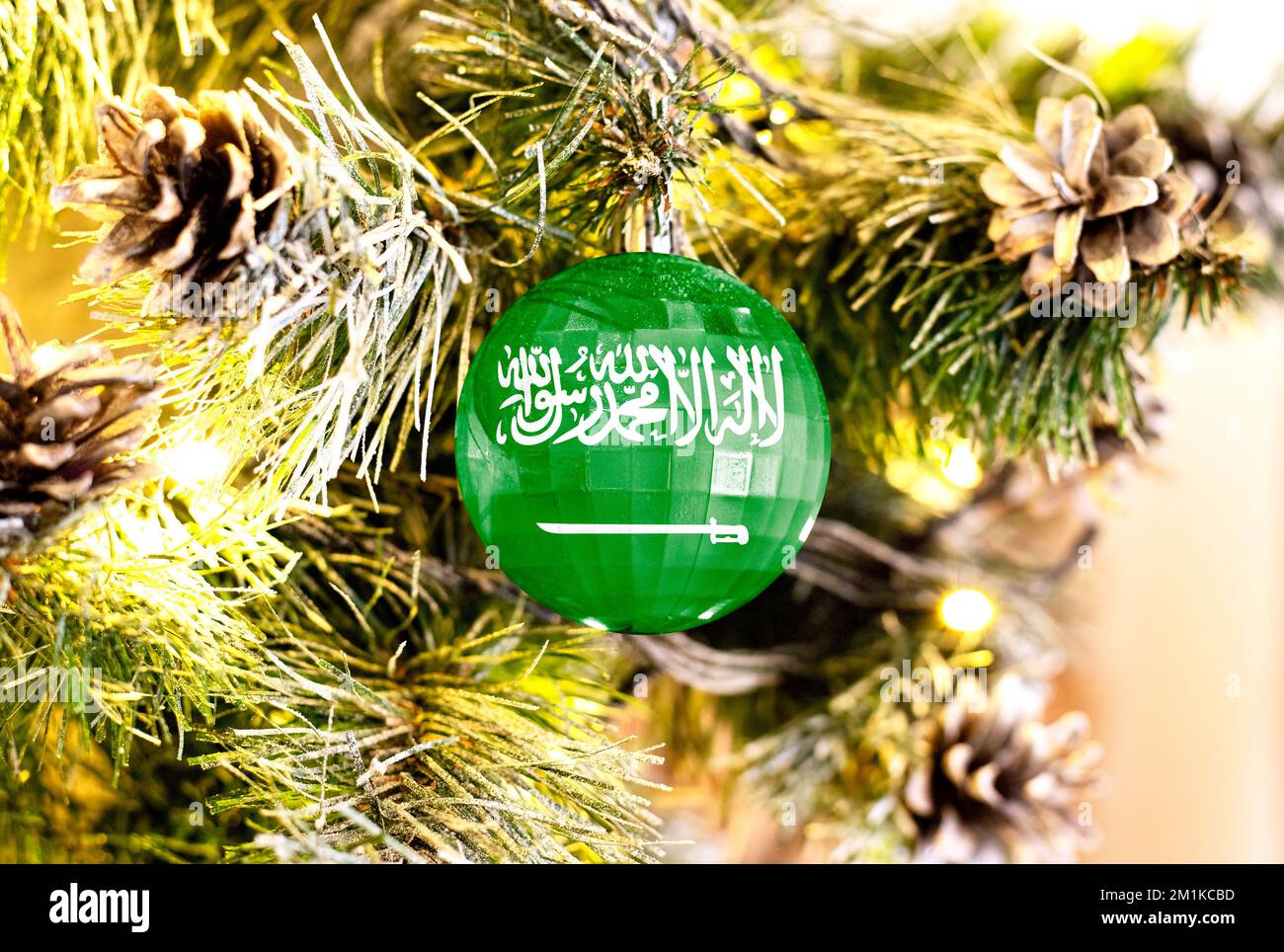 New Year's glass ball with the flag of Saudi Arabia against a colorful ...
