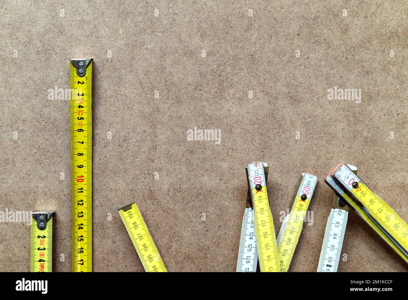yellow measuring tapes on mdf background - carpentry cpncept Stock ...