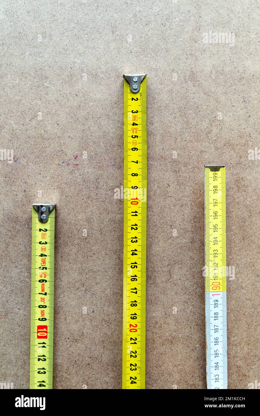 yellow measuring tapes on mdf background - carpentry cpncept Stock ...