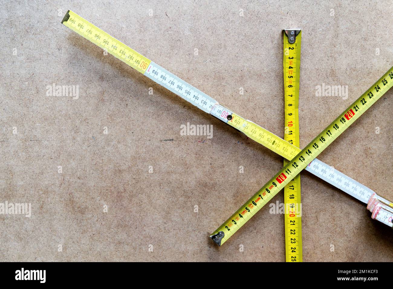 yellow measuring tapes on mdf background - carpentry cpncept Stock ...