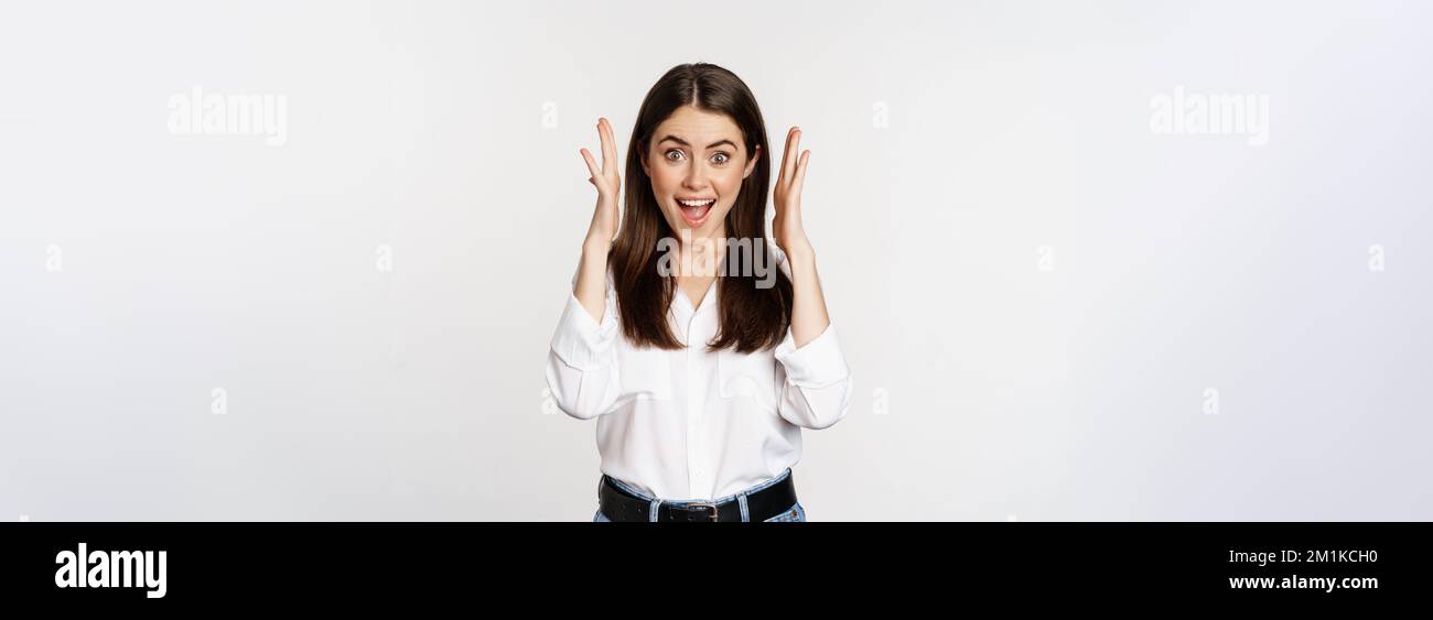 Excited young adult woman reacting to win, surprise news, screaming and ...