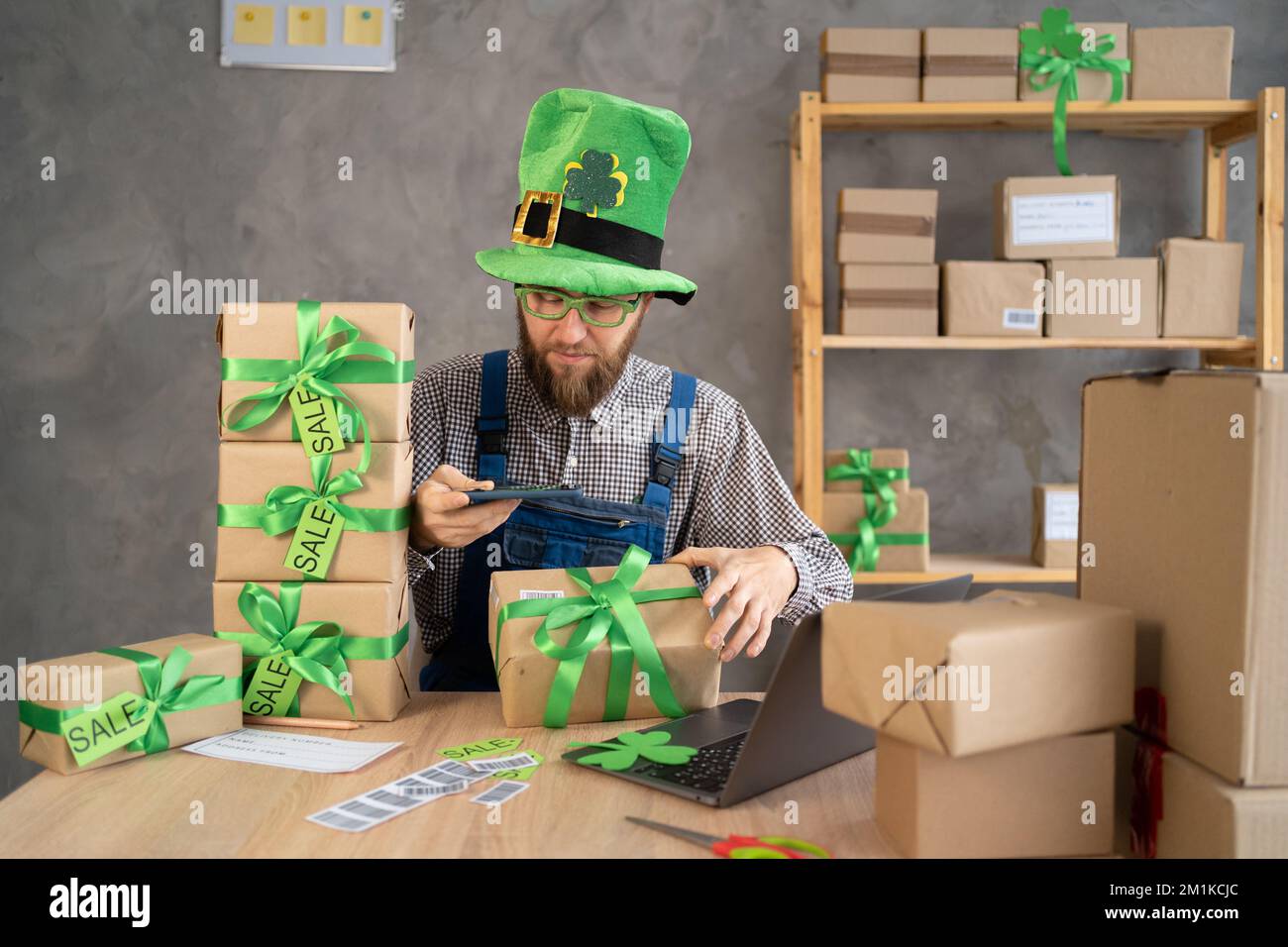 male small business owner using mobile app on smartphone checking ...