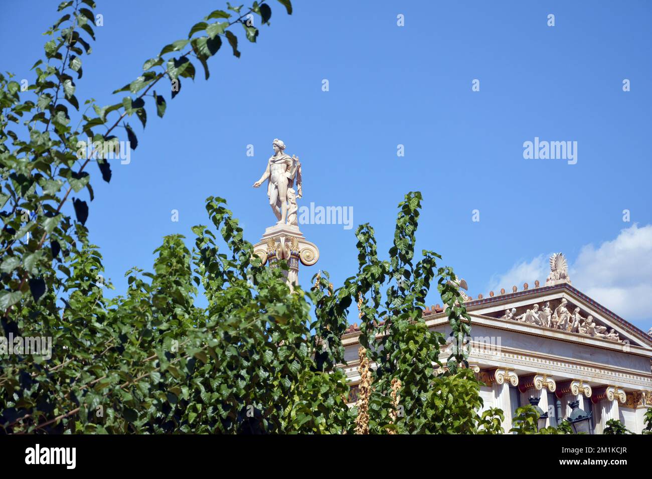 Statue of god Apollo and detail of the 19th century building of the ...