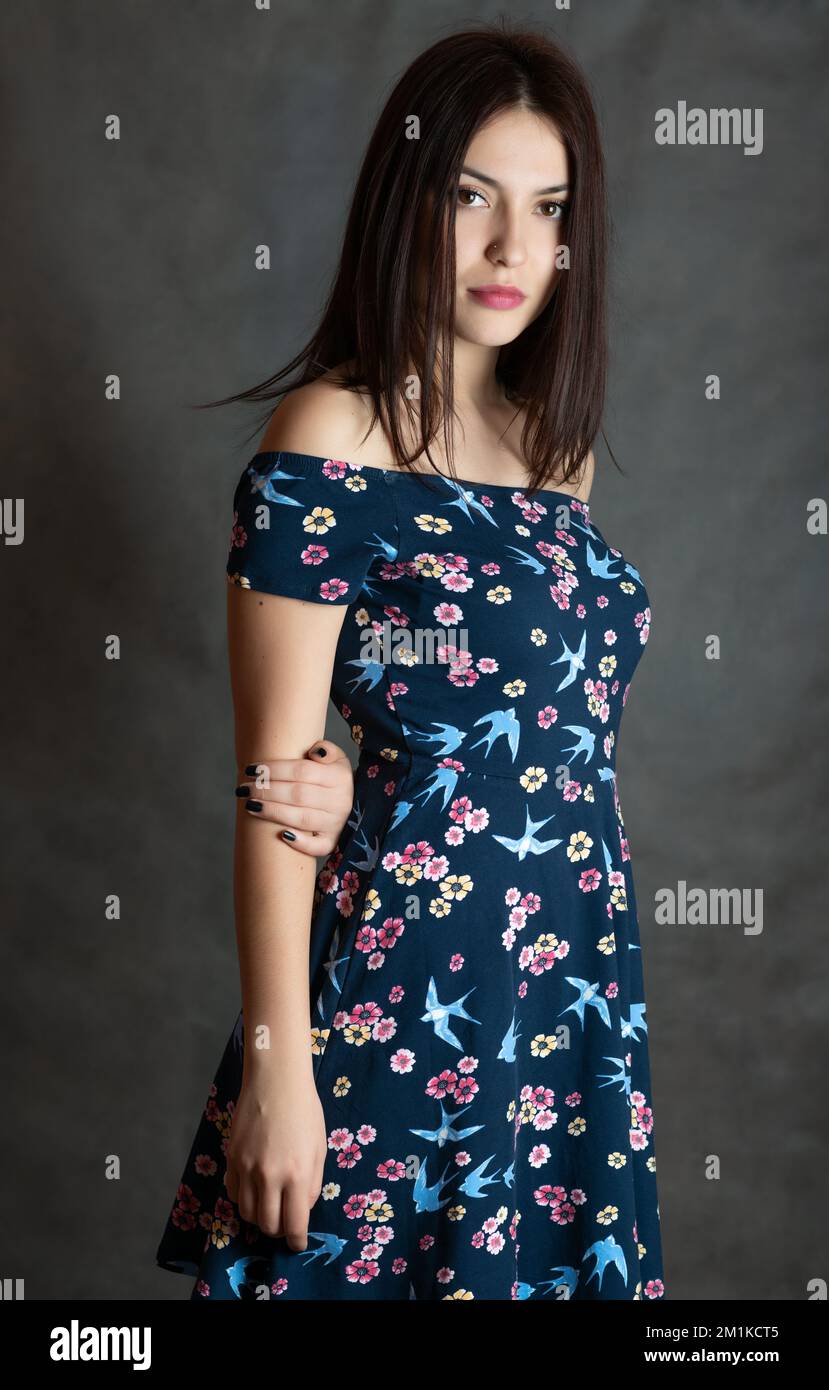 Happy beautiful woman in sundress on grey background Stock Photo - Alamy