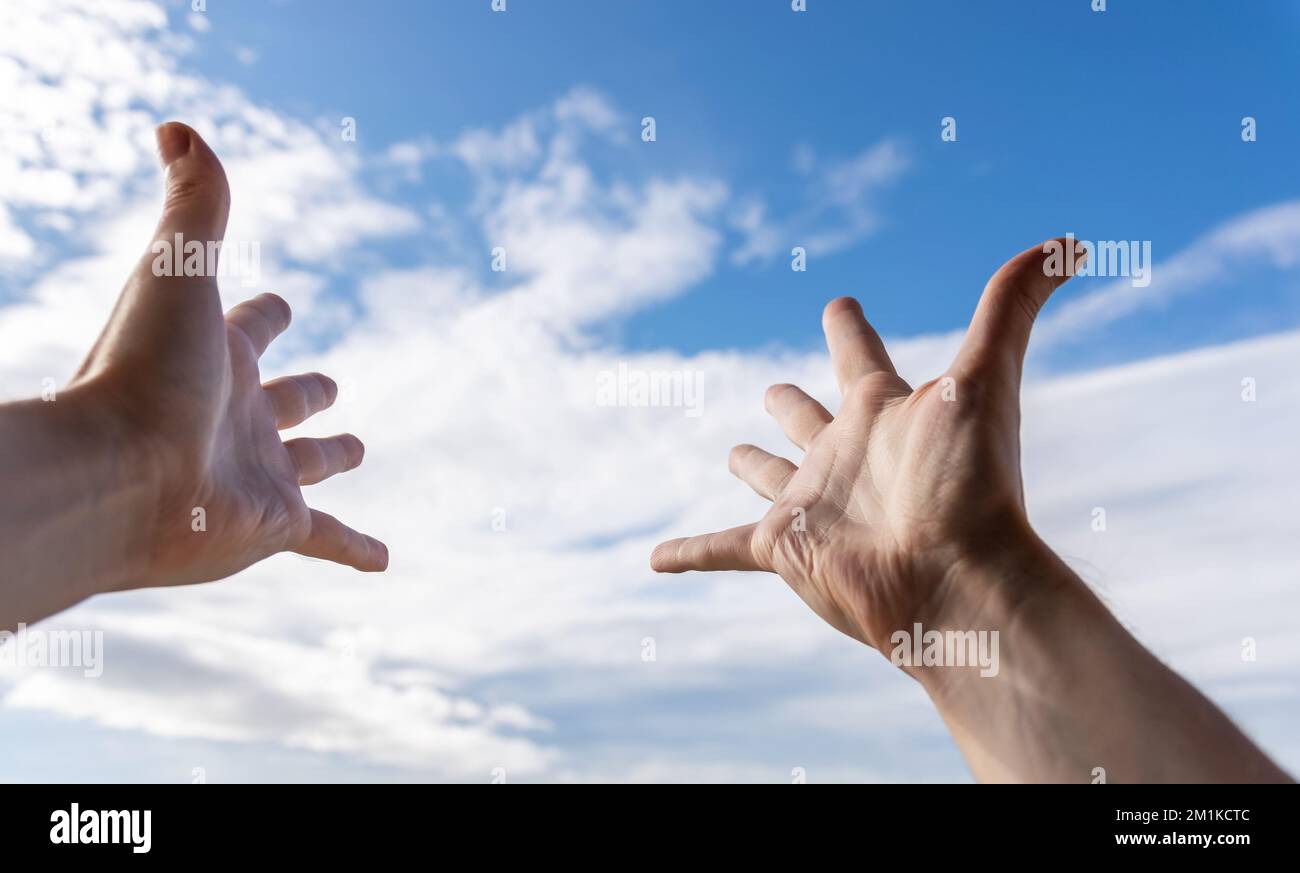 Hands of a man reaching to towards sky Stock Photo - Alamy