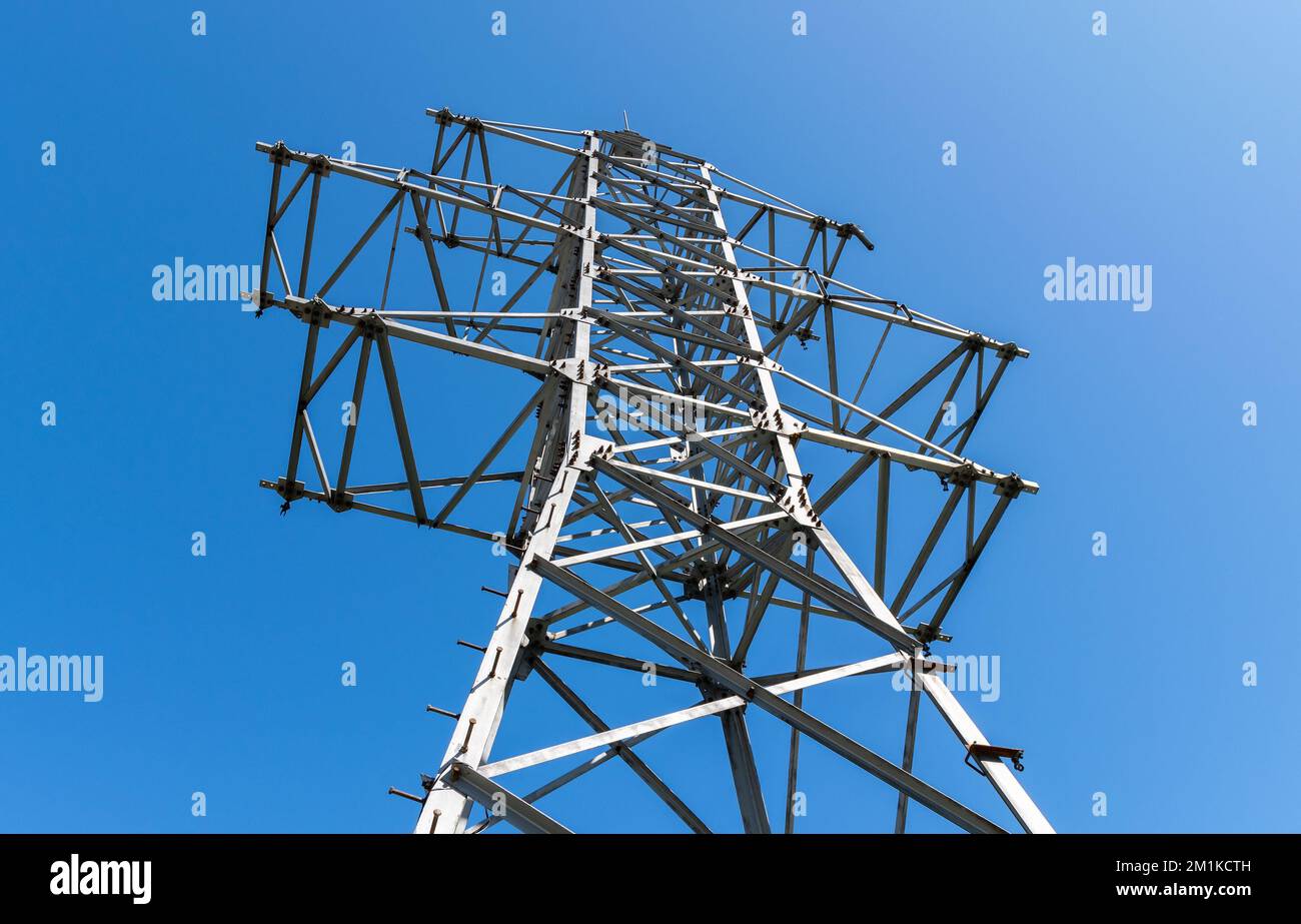 High-voltage tower against blue sky Stock Photo - Alamy