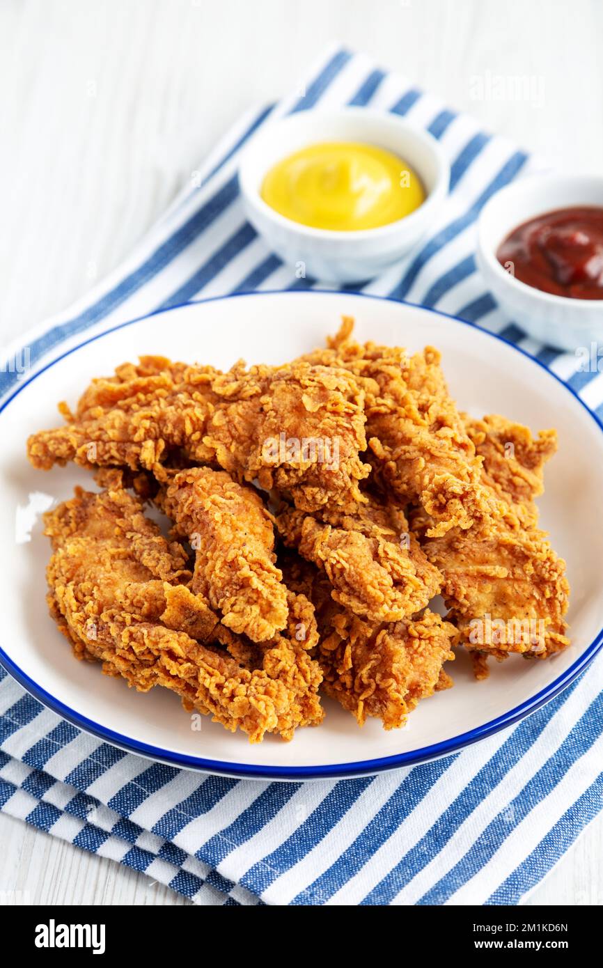 Homemade Chicken Strips with Mustard and BBQ on a Plate, side view ...