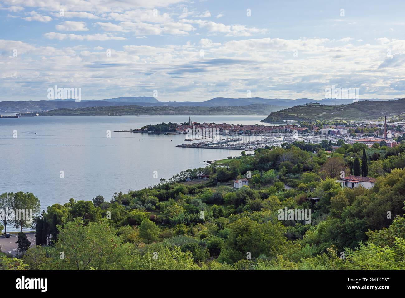 Overview of Izola and its coastline with ships awaiting to enter Koper ...