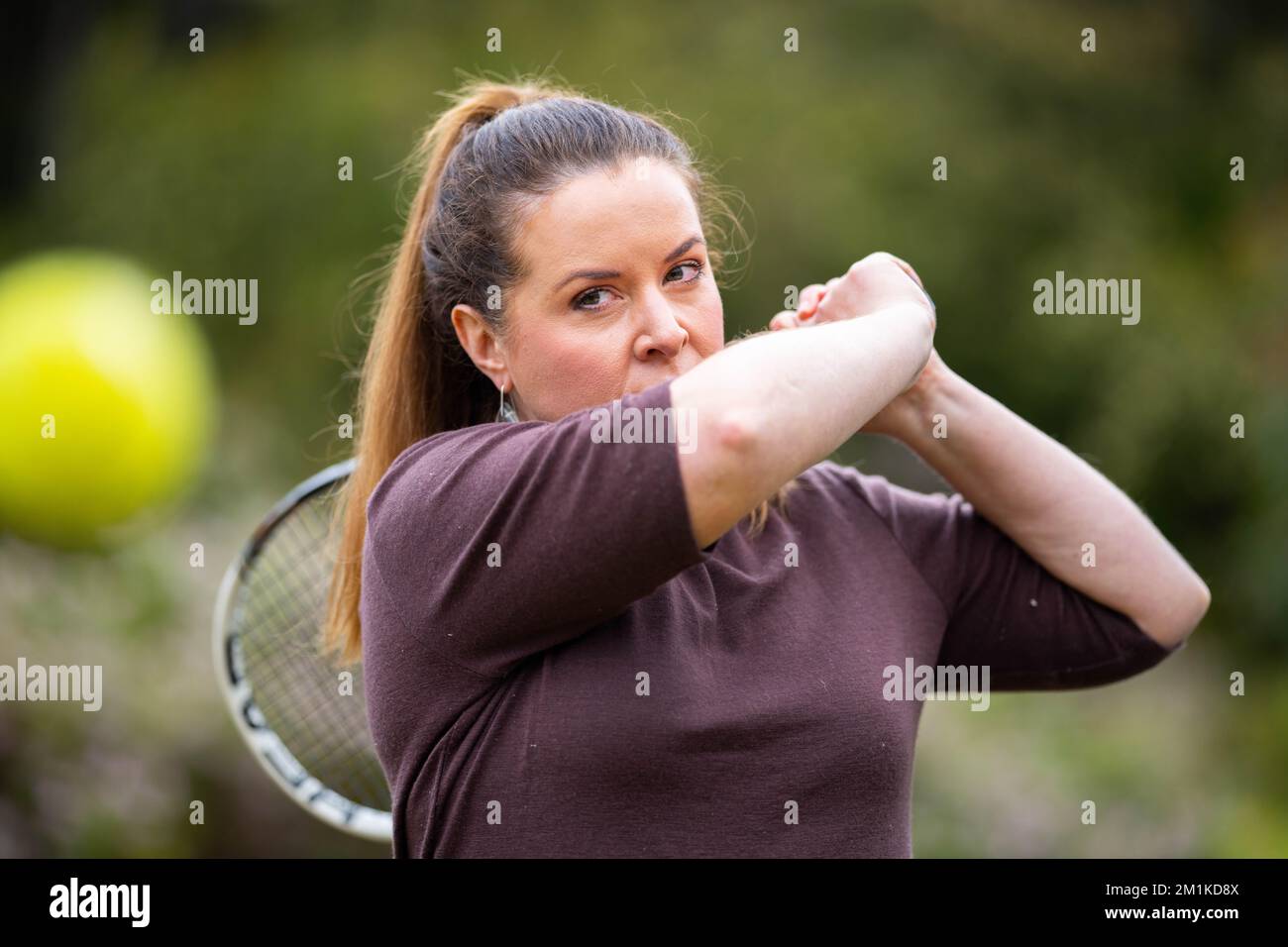Beautiful female athlete playing tennis. Amateur female tennis player ...