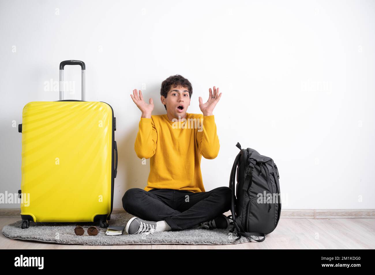 shocked traveler young man in sweater and with suitcase screaming and ...