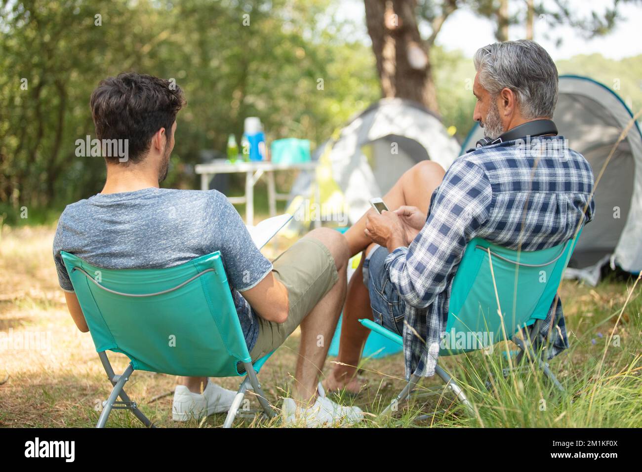 two men sitting next to a tent Stock Photo - Alamy two men sitting next to a tent Stock Photo - Alamy