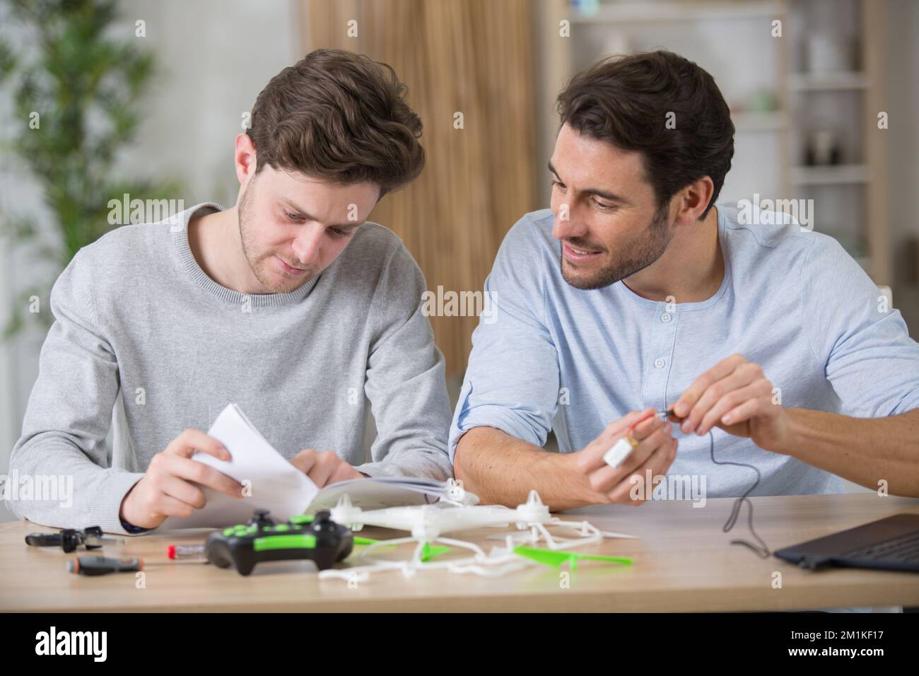 men are fixing a drone Stock Photo - Alamy