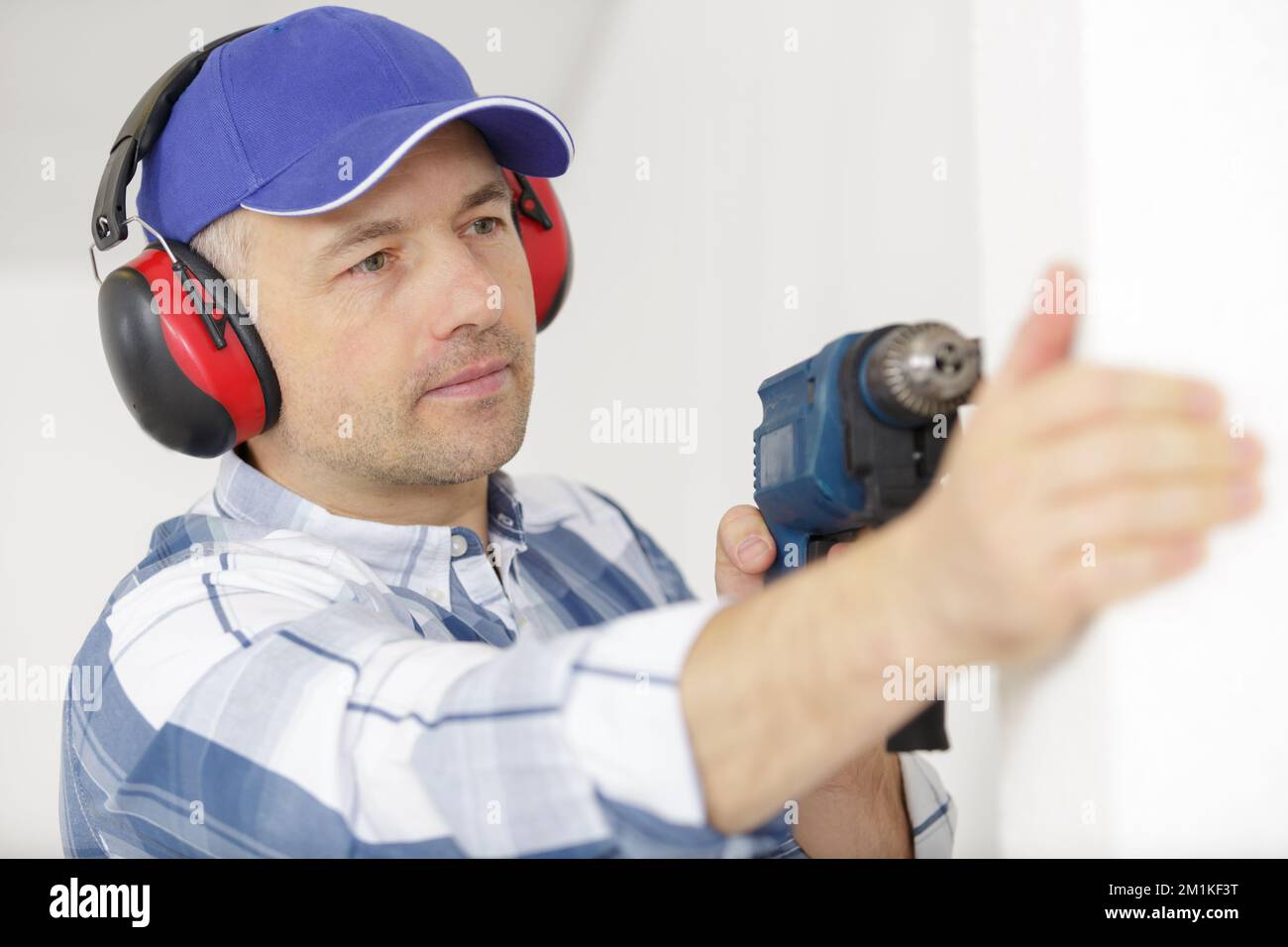 male carpenter using electrical drill Stock Photo - Alamy