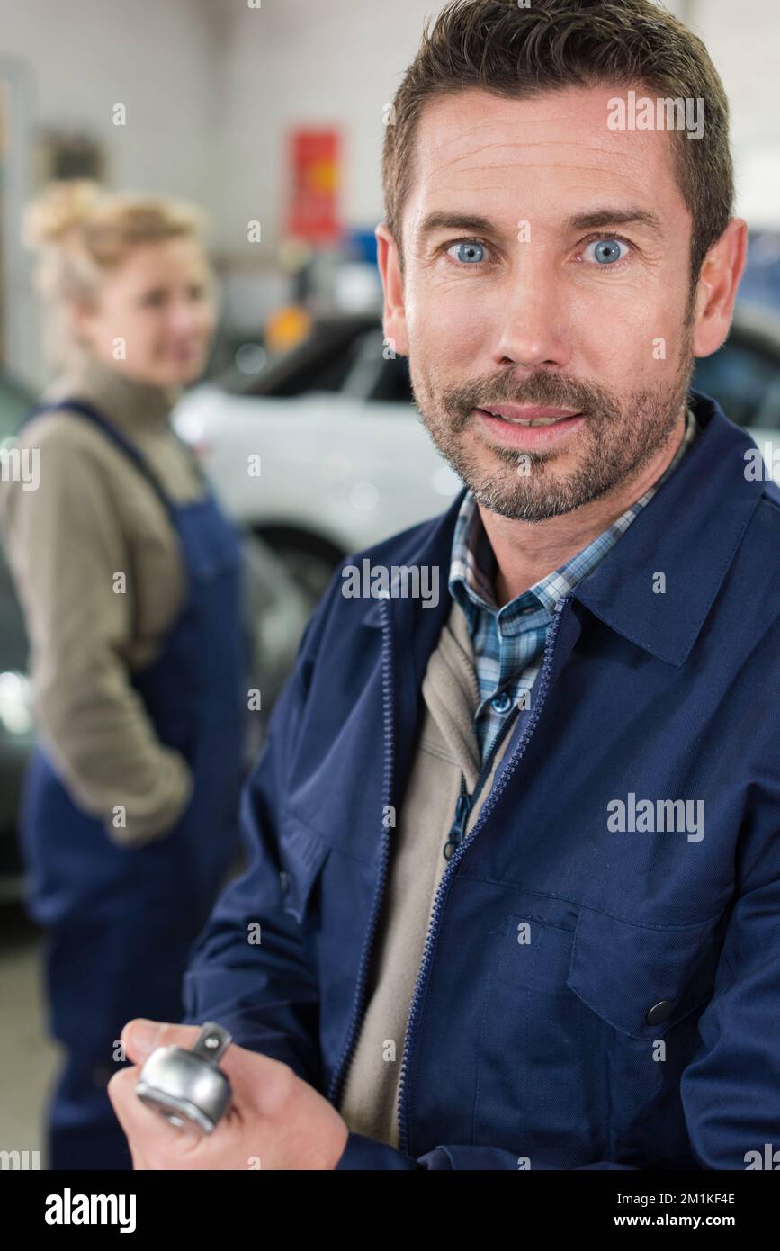 a mechanic holding a wrench Stock Photo - Alamy