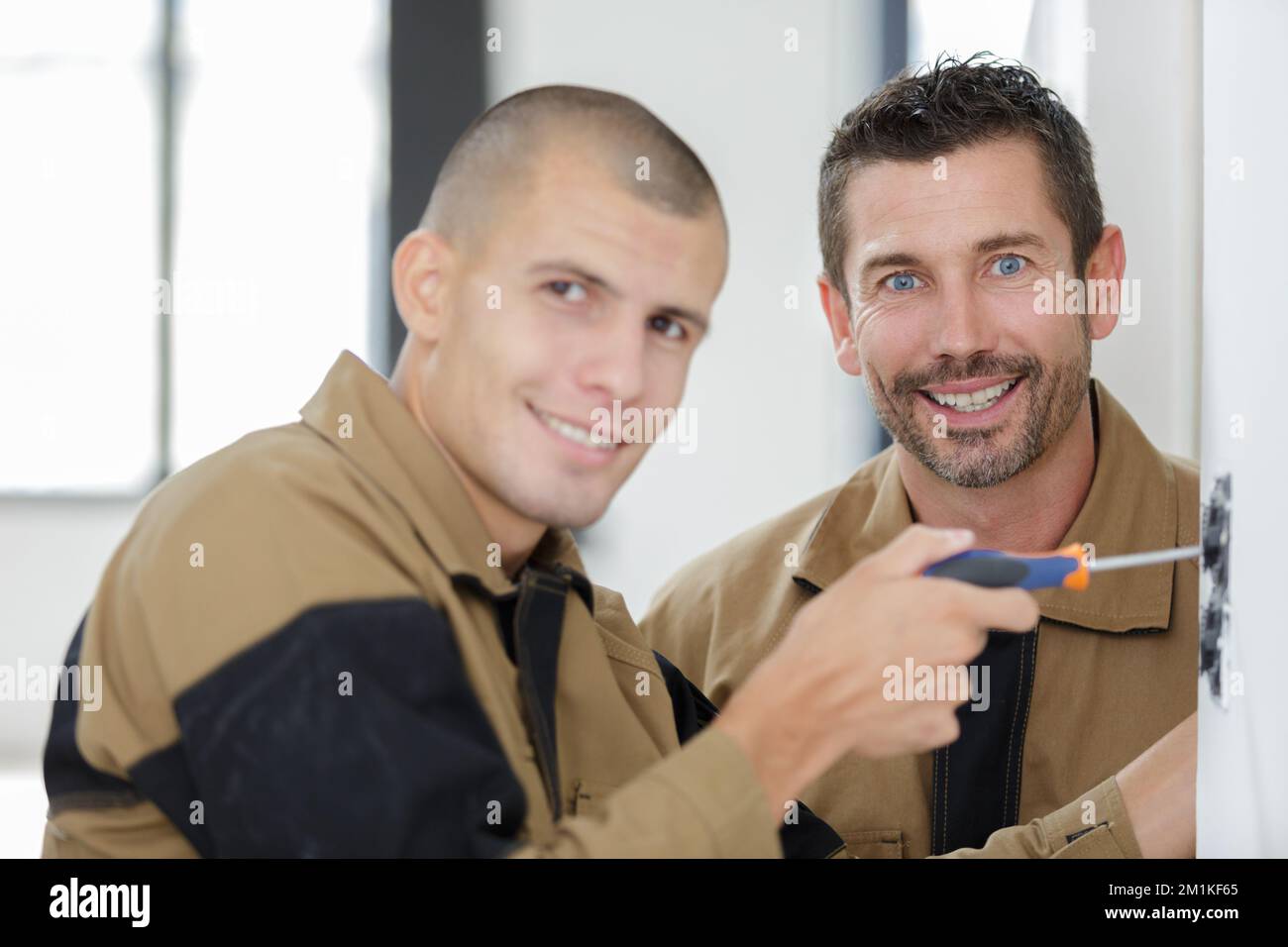 portrait of tradesman with his apprentice Stock Photo - Alamy