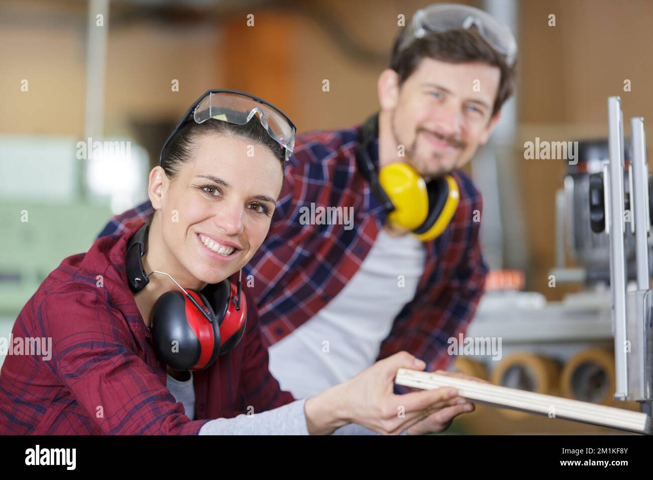 man explaining woman woodworking tips in wood workshop Stock Photo - Alamy