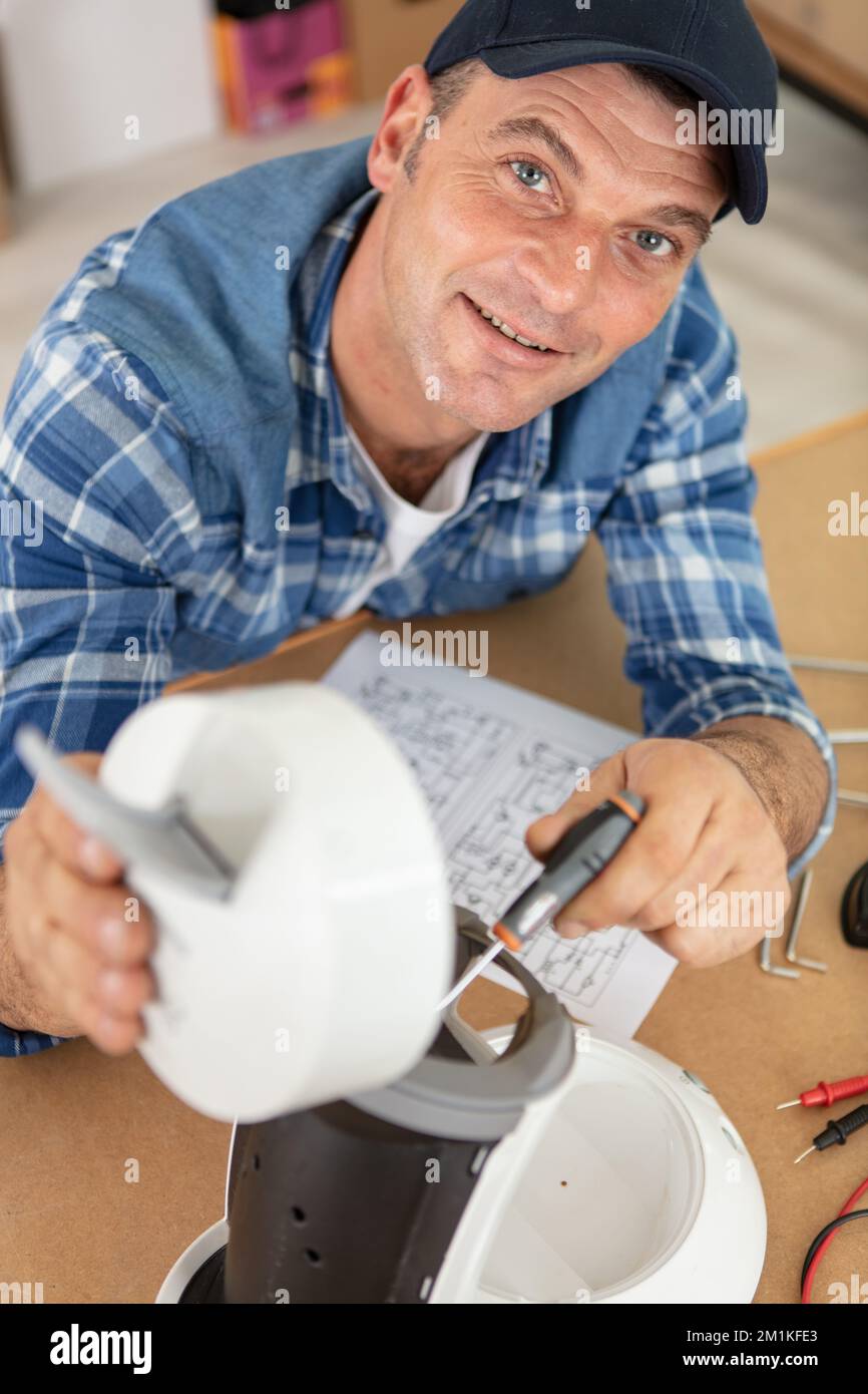 Repairman fixing coffee machine hi-res stock photography and images - Alamy