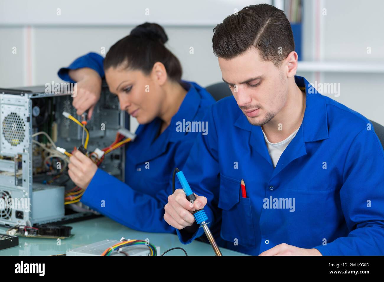 team of students examining and repairing computer parts Stock Photo - Alamy