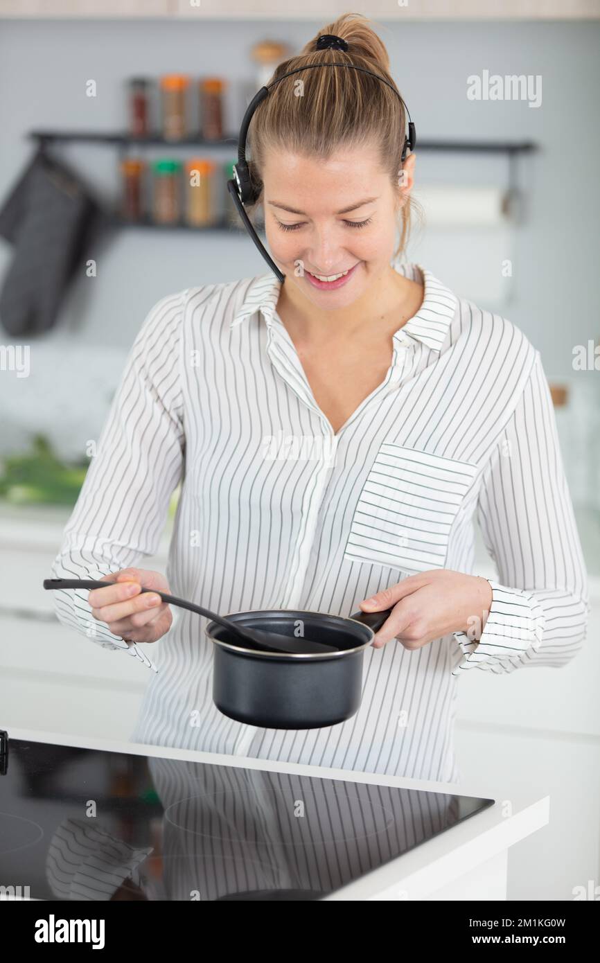 young woman cooking in modern kitchen and working Stock Photo - Alamy