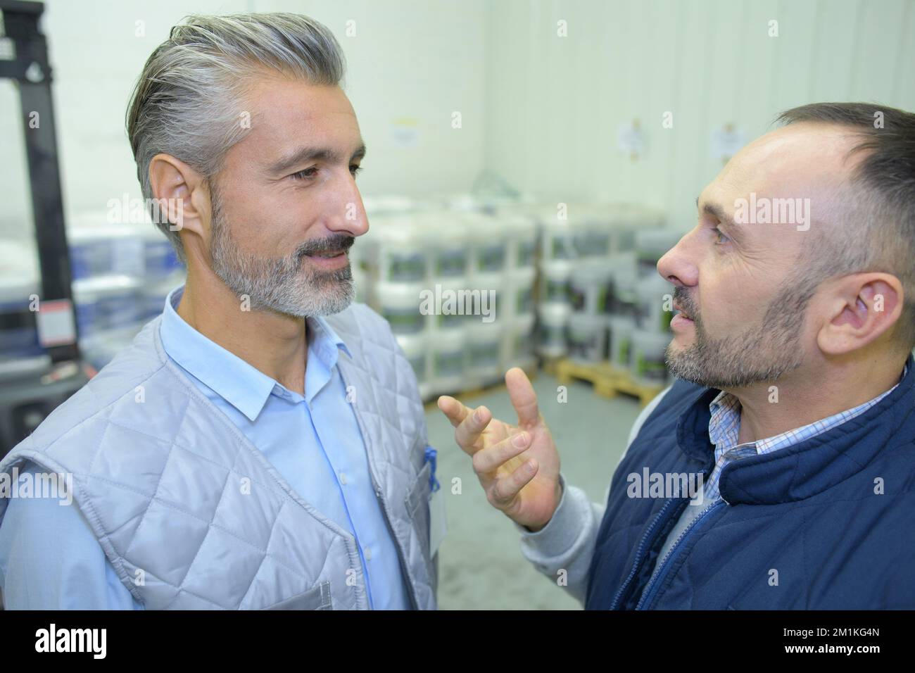 warehouse worker talking to boss Stock Photo - Alamy