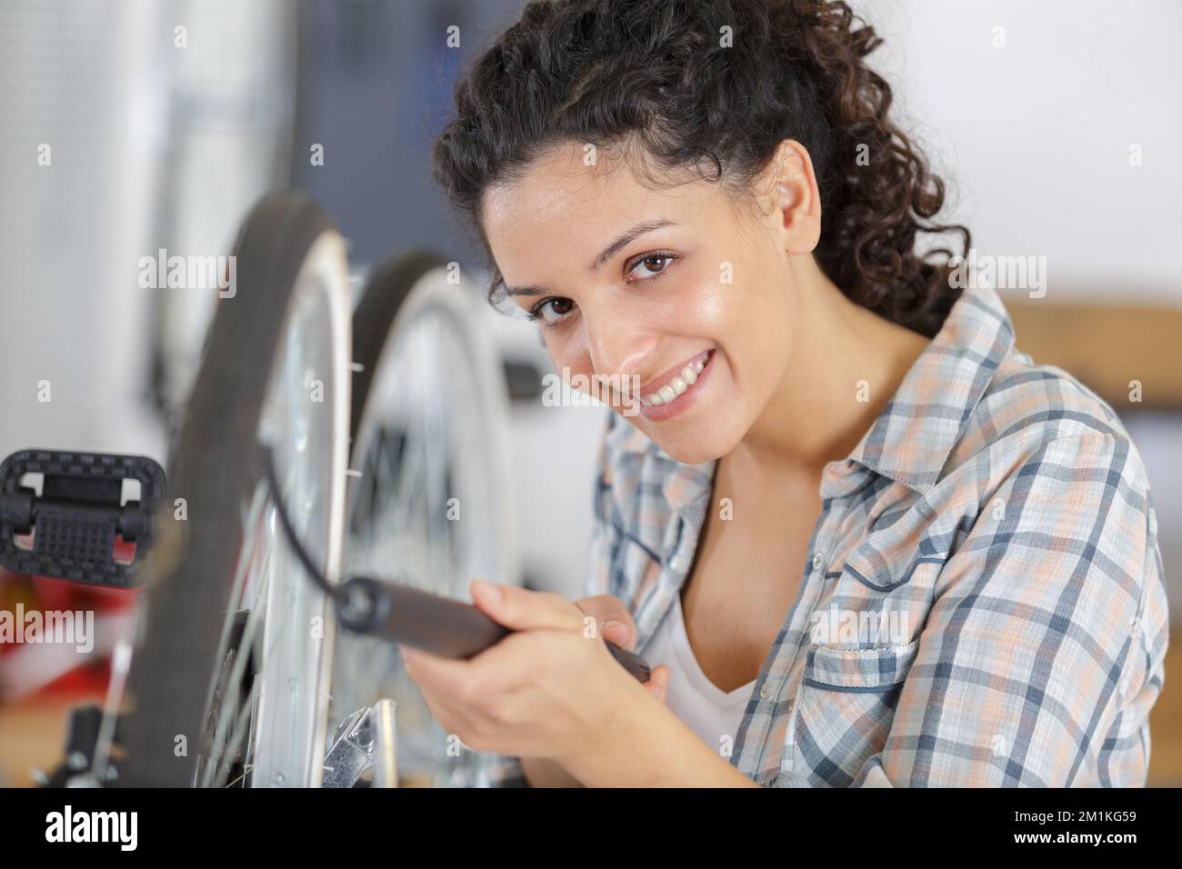 a woman pumping-up a flat bike Stock Photo - Alamy
