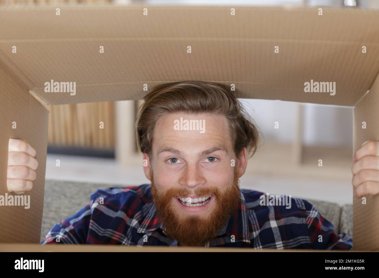 happy man looking into a box Stock Photo - Alamy