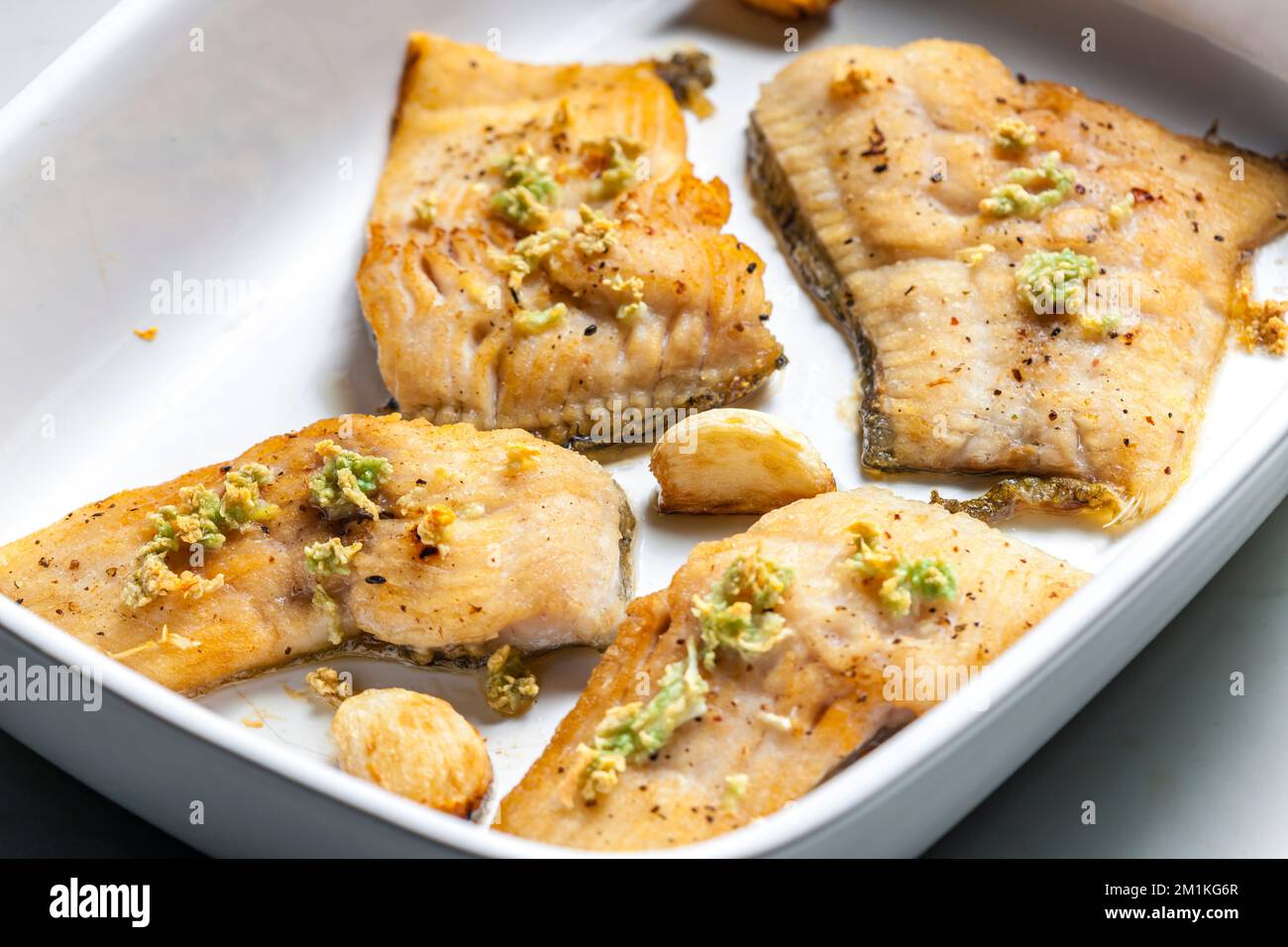 salmon trout baked with garlic Stock Photo - Alamy