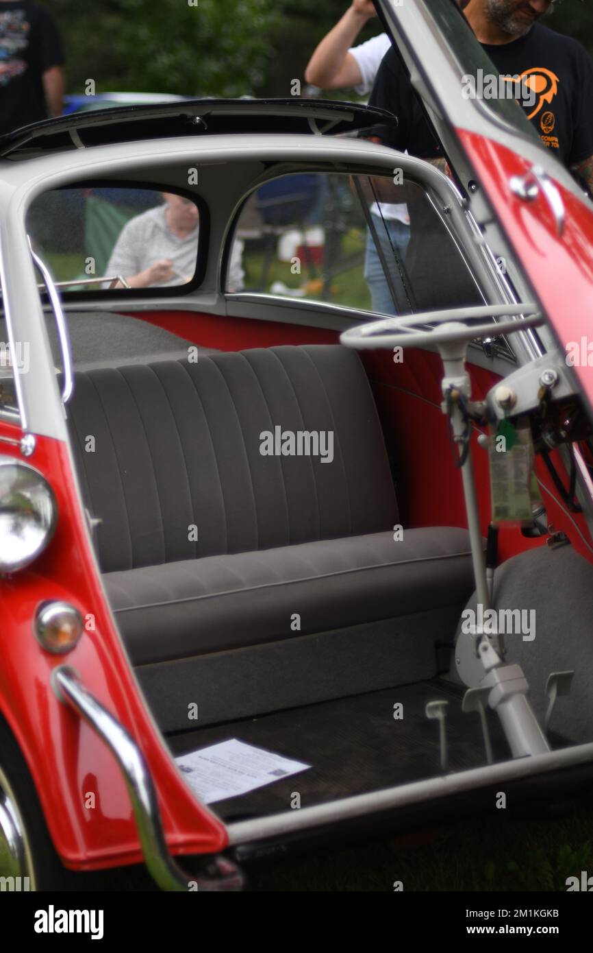 A vertical shot of a red and white vintage Isetta at the Hampshire ...