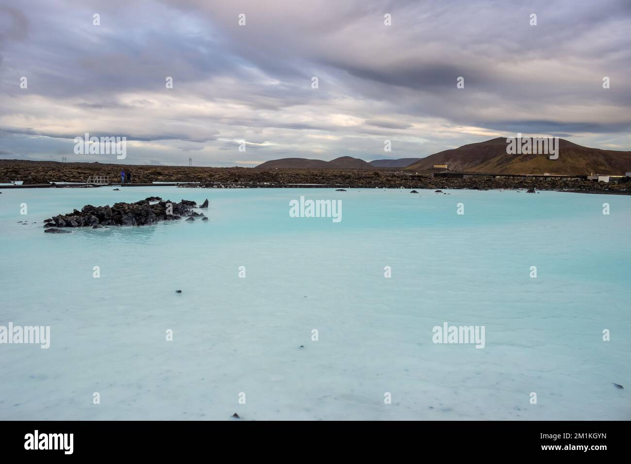 Late afternoon with a heavy clouds on the sky. Turqoise spring water of ...