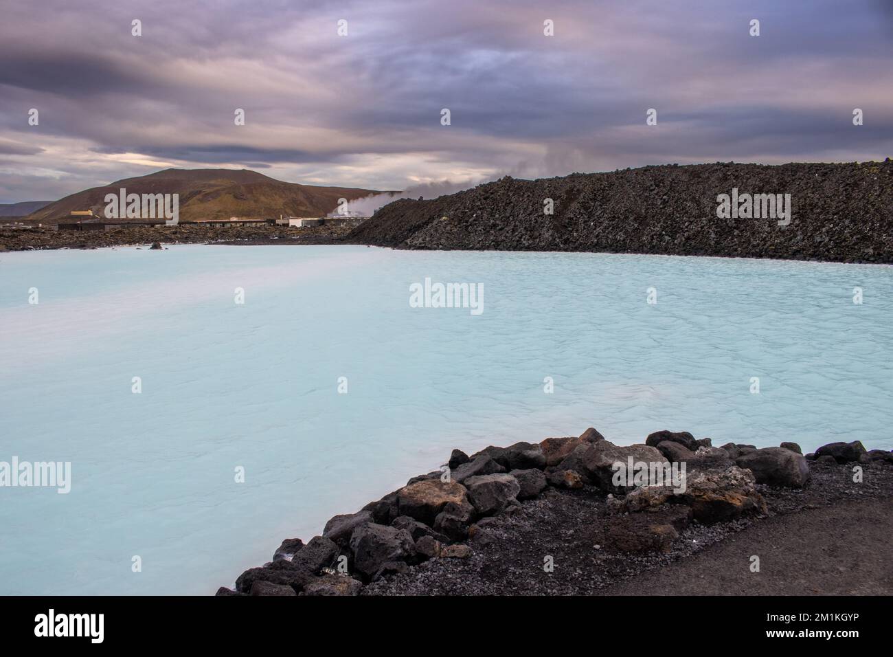 Late afternoon with a heavy clouds on the sky. Turqoise spring water of ...