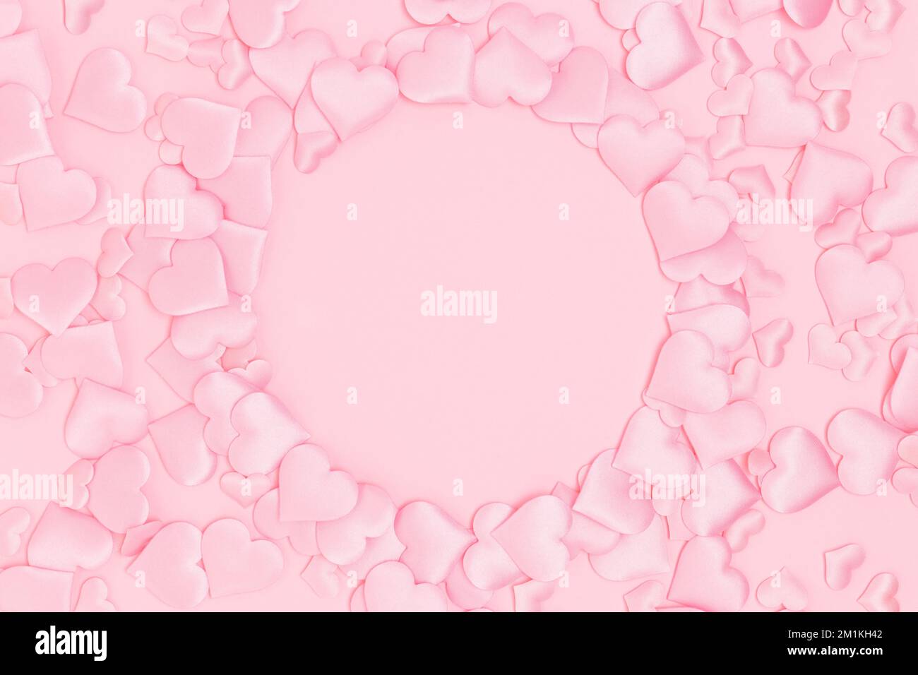 Round frame made of textile pink confetti in a heart shape. Monochrome ...