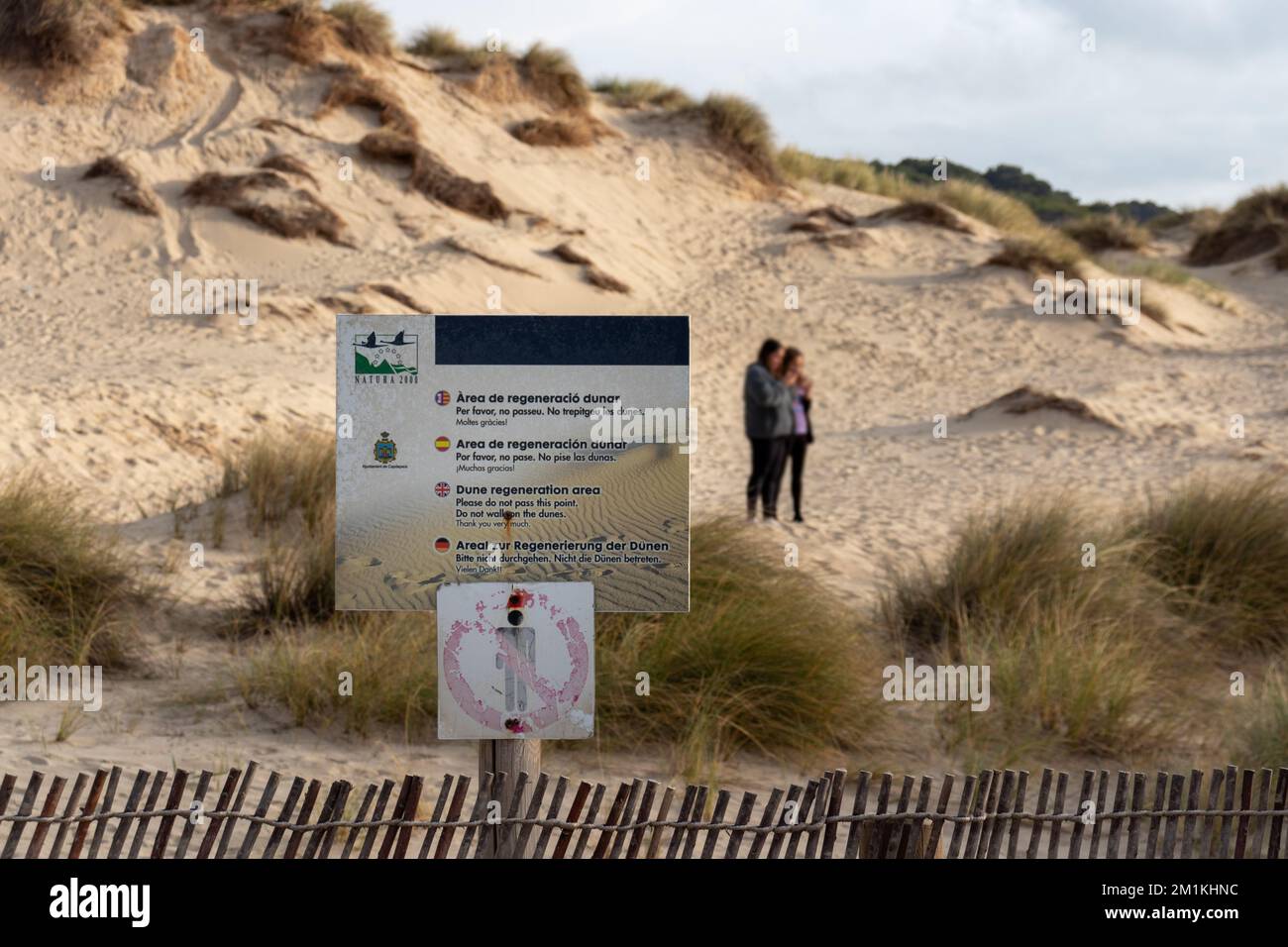 People ignoring nature protection and preservation sign walking on ...