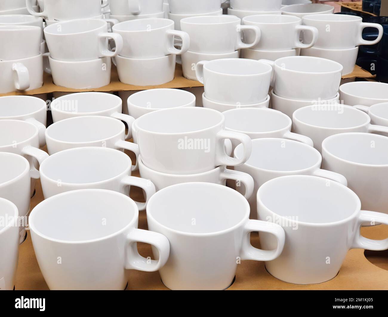 White cups a lot. Store warehouse Stock Photo - Alamy
